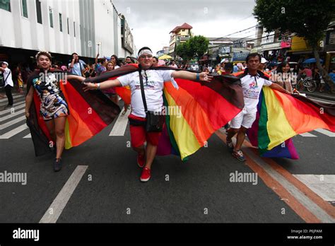A Pride March Participant Wearing A Colorful Costume Thousands Of Gay