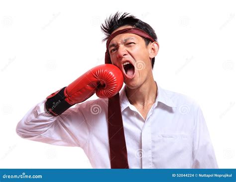 Business Man Hitting Himself With A Red Boxing Glove In The Face Stock