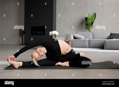 A Young Slim Woman Has Done Splits And Is Stretching Herself With Her