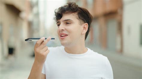 Non Binary Man Smiling Confident Talking On Smartphone At Street Stock Image Image Of Adult
