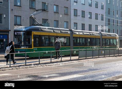 Man Smoking At Kansaneläkelaitos Tram Stop With Tram On Line 4 In The