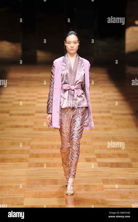 A Model Displays A New Creation At The Asahi Kasei Chinese Fashion