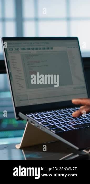 Vertical Video Engineer In Data Center With Laptop Automating Routine Maintenance Tasks