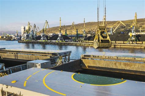 Loading Coal Into The Holds Of Bulk Carriers In The Seaport Stock Photo
