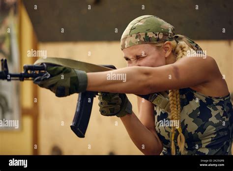 Young Beautiful Military Woman Holding Rifle And Take Aim Ready To