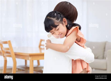 Japanese Mother Hugging Daughter Stock Photo Alamy