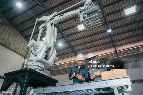 Two Engineers Industrial Engineers Are Working And Inspecting Robotic
