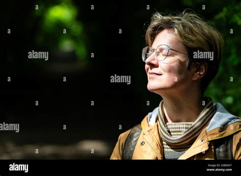 Portrait Of A 38 Yo White Woman Eyes Closed With A Dark Green Nature