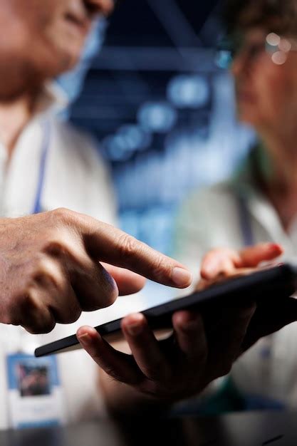 Premium Photo Efficient Coworkers Using Tablet To Examine Rackmounts For Power Fluctuations