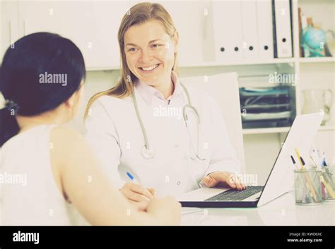 Young Woman Having Consultation With Female Doctor In Hospital Stock