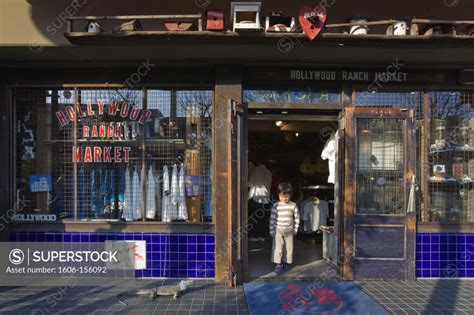 A Little Japanese Boy Seems Pretty Sure The Iguana Chained Outside Is