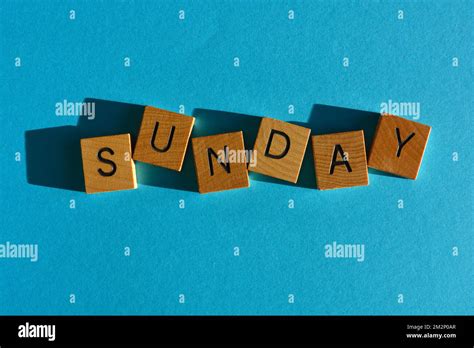 Sunday Word In Wooden Alphabet Letters Isolated On Bright Blue