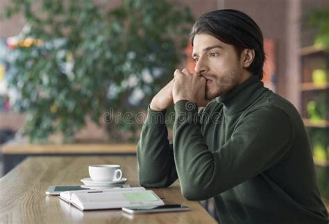 Frustrated Man Having Problems With Job Sitting At Cafe Stock Image