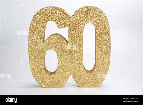 A Gold Glittery Sign That Says The Number On A White Background