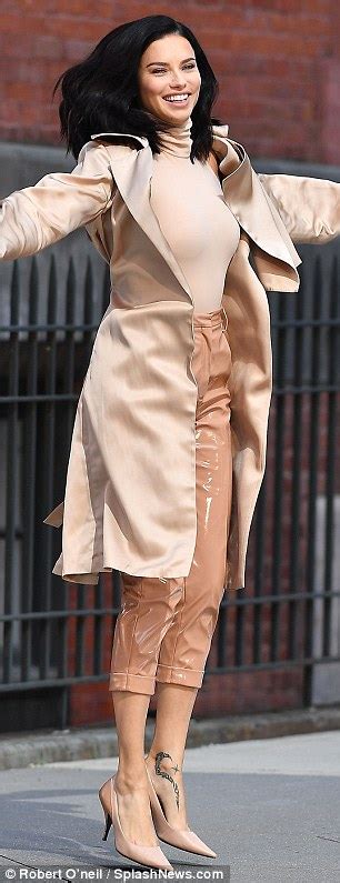 Adriana Lima Works Her Magic In Nude PVC Trousers And Tight Turtleneck As She Films Maybelline