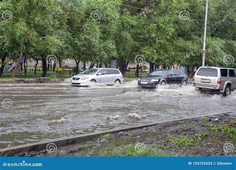 Cars Drive Through Deep Puddles On The Road After Rain Editorial Stock