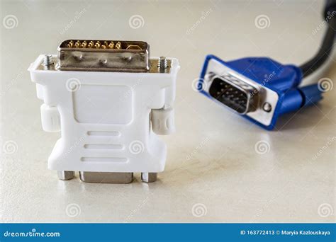 White Adapter For Connecting Dvi D And Vga And Blue Monitor Cord Behind It Connection Of