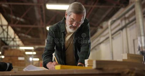 Workshop Senior Man Or Carpenter With Drawing Design Sketch And