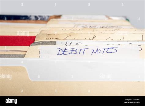 Group Of Paper File Folders With Hand Written Debit Notes Label