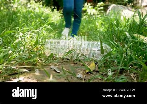 Close Up Of Volunteers Sit And Picking Up Garbage In The Park