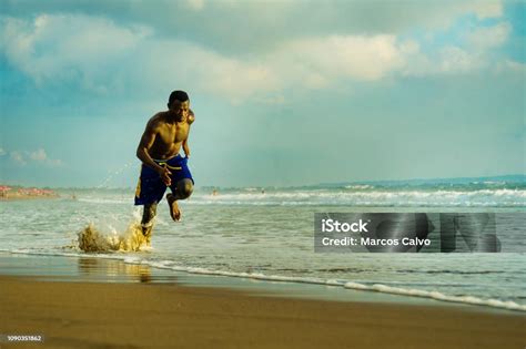 매력적인 젊은 운동과 강한 아프리카계 미국인 흑인 비치 훈련 열심히 하 고 역주에서 프로 선수 생활에서 바다 물에 실행 하 고 찢 어 러너 운동 단거리 경기에 대한 스톡