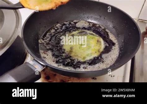 The Vegeterian Green Pees Bread Being Fried In Heated Oil In A Black