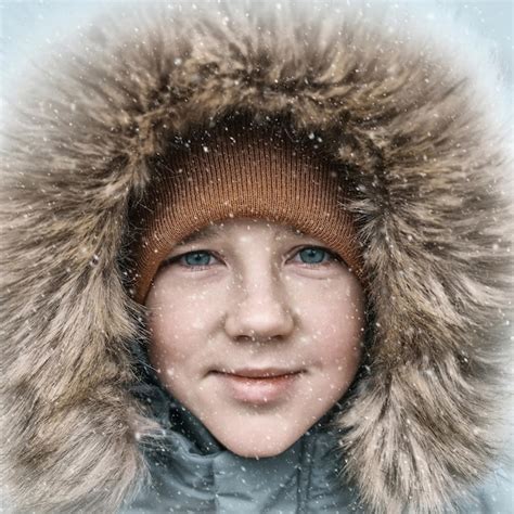 Premium Photo Close Up Portrait Of Smiling White Boy In Hood Winter