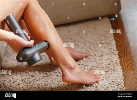 Self Massage Of Womens Legs With A Perfecting Gun At Home Shock