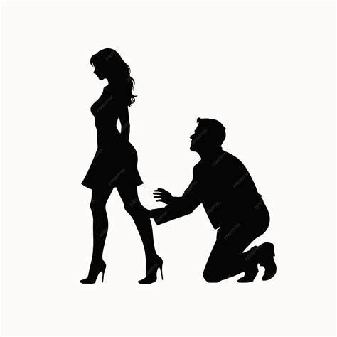 Мужчина на коленях и держит руку женщины Мужчина коленичит на земле с согнутыми коленями и