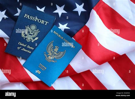 Passport Of Indonesia With Us Passport On United States Of America Folded Flag Close Up