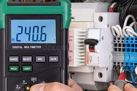 Voltage Measurement With Digital Multimeter In Electrical Panel Stock