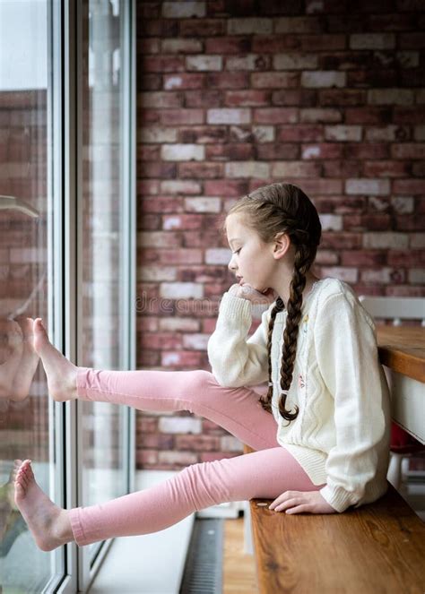 The European Girl Is Sitting On The Ground Bare Feet Long Hair Stock