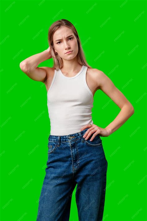 Premium Photo Young Woman In White Tank Top And Blue Jeans Posing