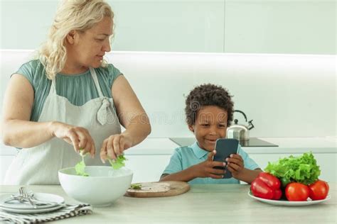 Mom And Her Son With Phones On Kitchen Stock Image Image Of Family