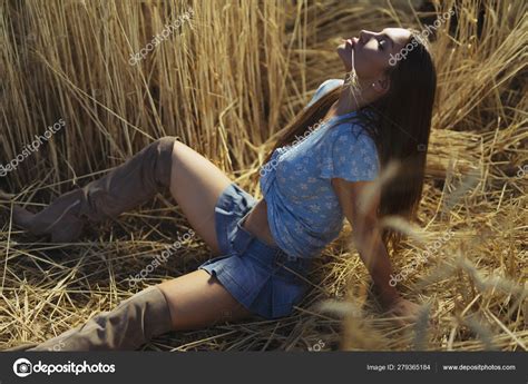 Sexy Peasant Woman In Mini Skirt Sitting On Wheat Field Stock Photo By