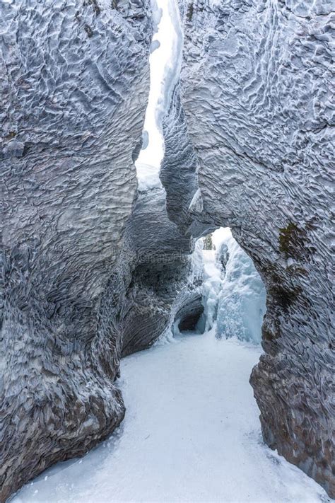 Ice Cave With Rock Formation Of Water Eroded On Winter Stock Image
