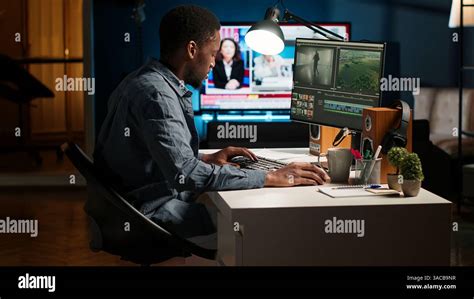 Young Filmmaker Working On Media Post Production From Agency Office Ensuring Editing Timeline Young Filmmaker Working On Media Post Production From Agency Office Ensuring Editing Timeline