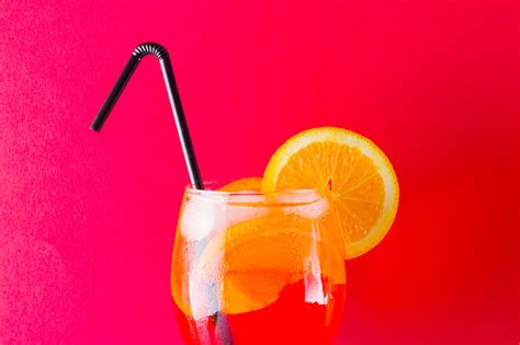 칵테일 아돌 붉은 파란색 배경에 뿌려 오렌지 조각과 함께 여름 알코올 칵테일 컬러 배경에 아페 롤 스 프리츠 미니 멀리즘 스타일의 산호 색 칵테일 0명에 대한 스톡 사진 및
