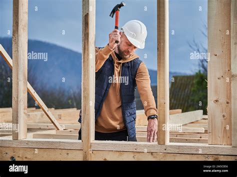 Man Worker Building Wooden Frame House Carpenter Hammering Nail Into