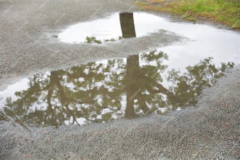 Premium Photo Reflective Water Puddle In The Street Formed After A