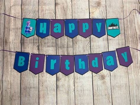 A Happy Birthday Banner Hanging On A Wooden Wall With Purple And Blue