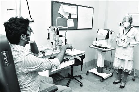Examiner With Personal Protective Equipments Testing The Distance