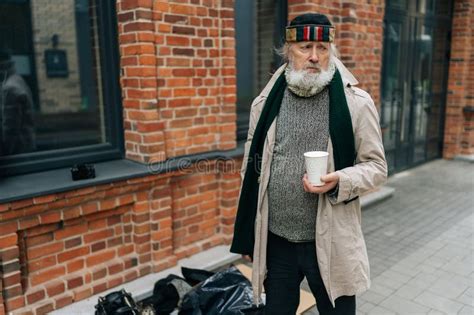 Portrait Of Senior Adult Homeless Man With Lengthy White Beard And Poor