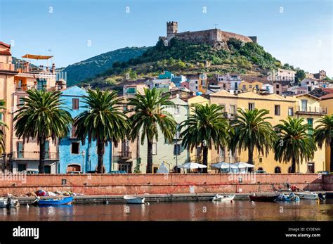 View Of The River The Town Of Bosa And The Old Fort On The Island Of