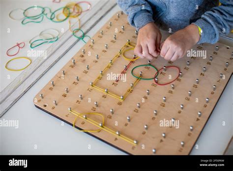 Exploring Basic Math And Geometry Concepts With Geoboard Stock Photo