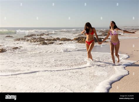 Happy Adult Caucasian Couple Having Fun On The Beach Hi Res Stock