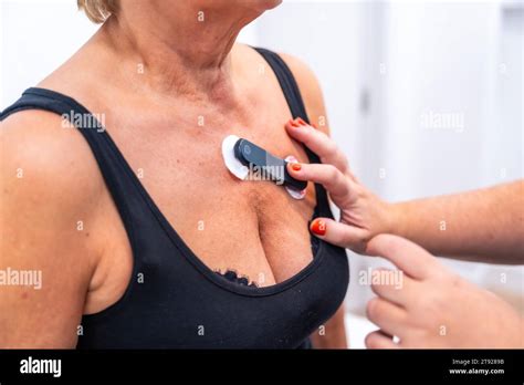 Female Doctor Putting Unrecognizable Woman With Heart Problems