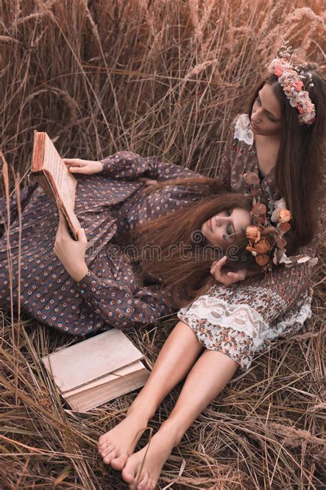 Fashion Portrait Of Two Beautiful Girls At The Sunset Field Wearing