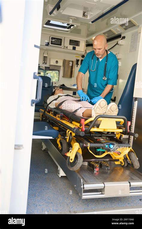 Doctor Fixes Body Of An Injured Woman On A Gurney Stock Photo Alamy