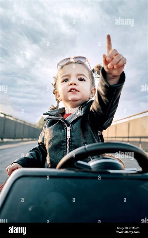 A Girl Riding A Toy Car Stock Photo Alamy